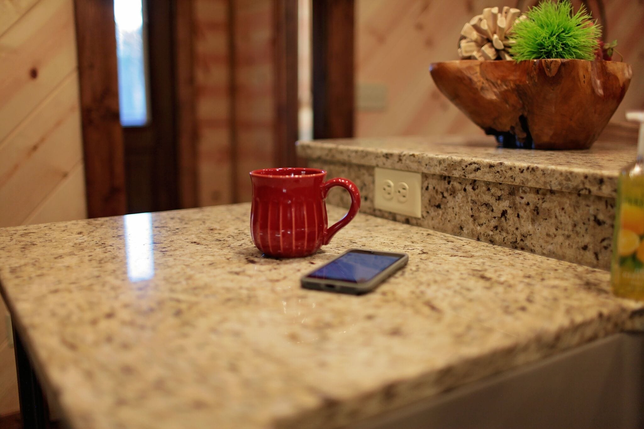 Cabin kitchen counter with coffee mug and cellphone - Blue Beaver Cabins